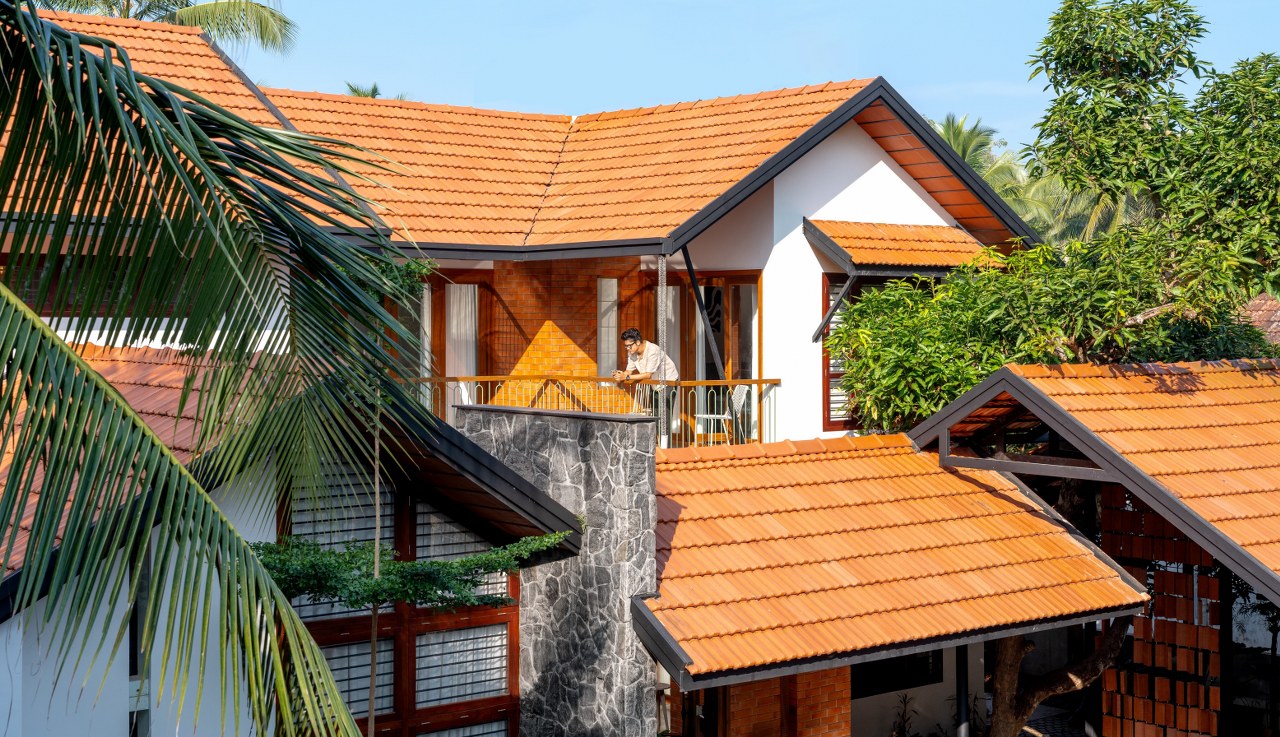 This Tropical Home Design Features A Striking Sloped Terracotta Roof In ...