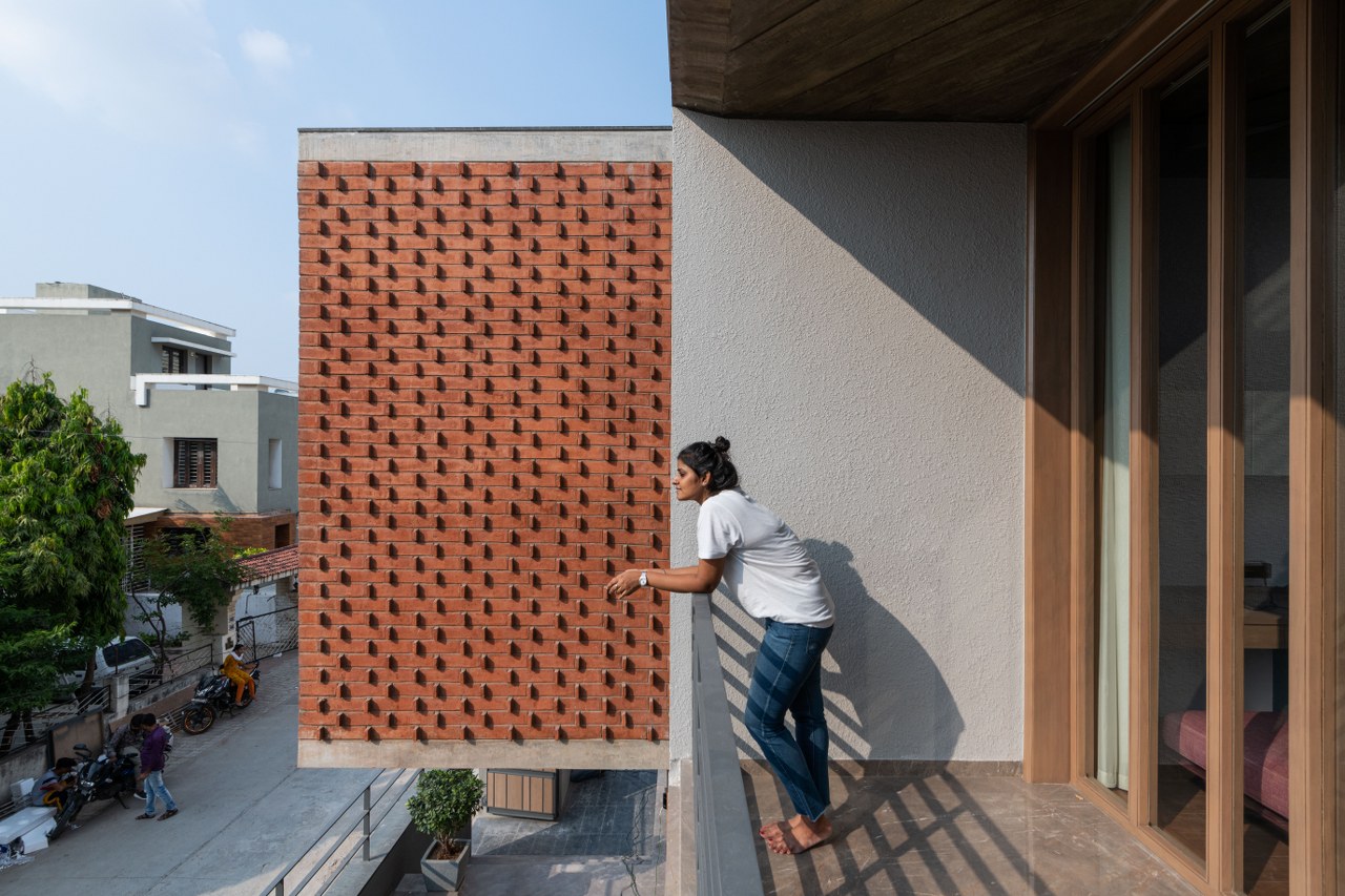 The Residence Features An Exposed Brick Design That Enhances Its Street ...